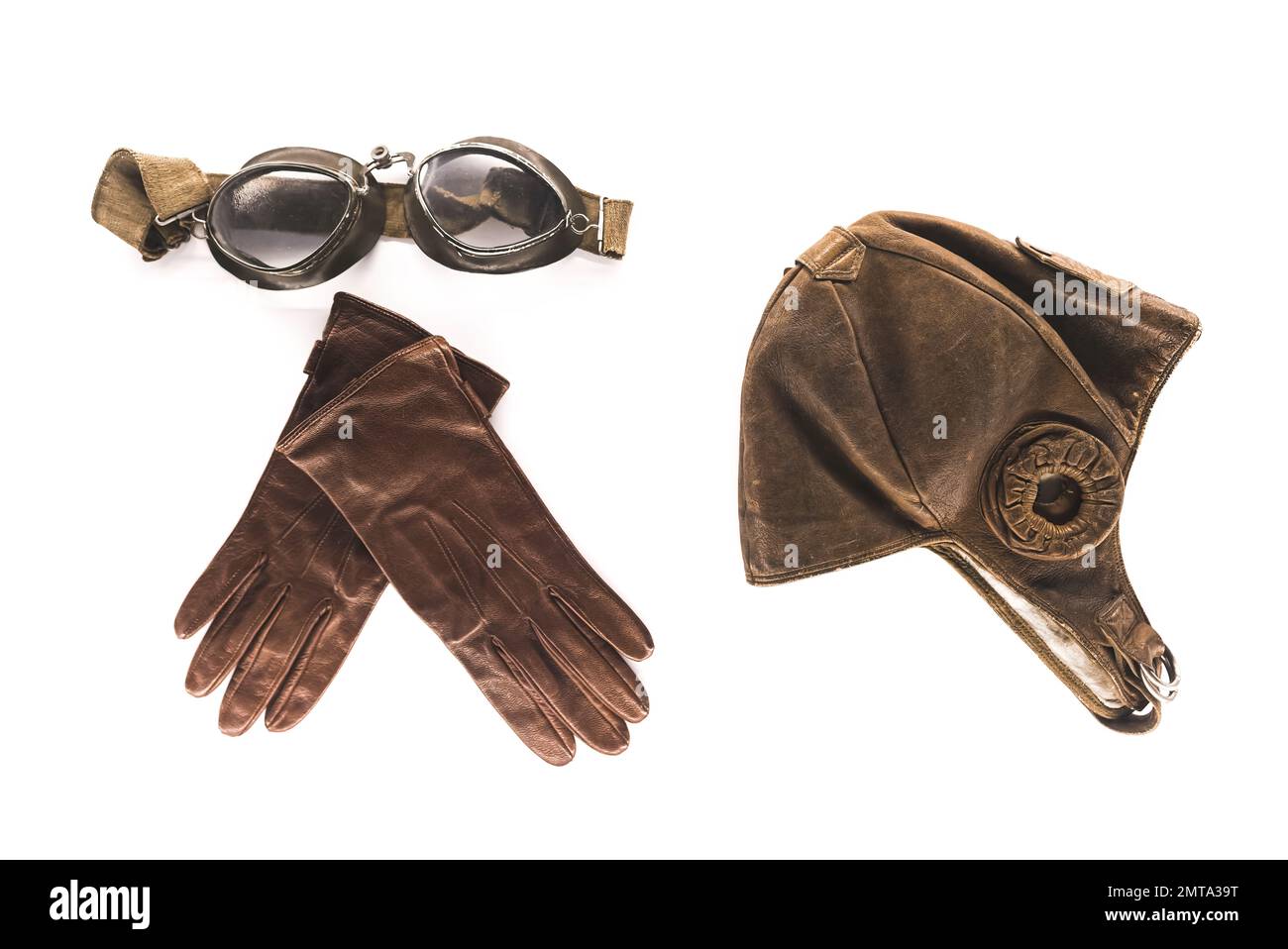 Retro aviator pilot equipment - helmet, goggles and gloves on a white ...