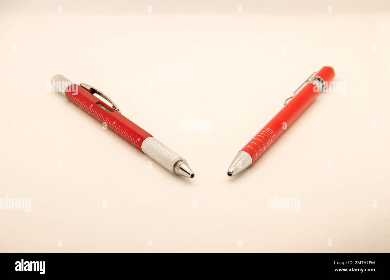 A view of two red pens on white background Stock Photo - Alamy
