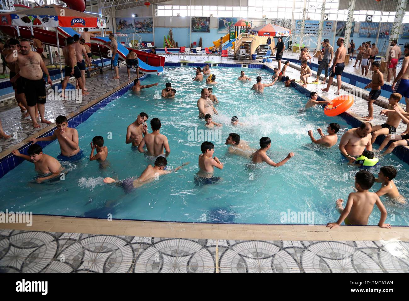 People escape the searing summer heat in a swimming pool in Baghdad ...