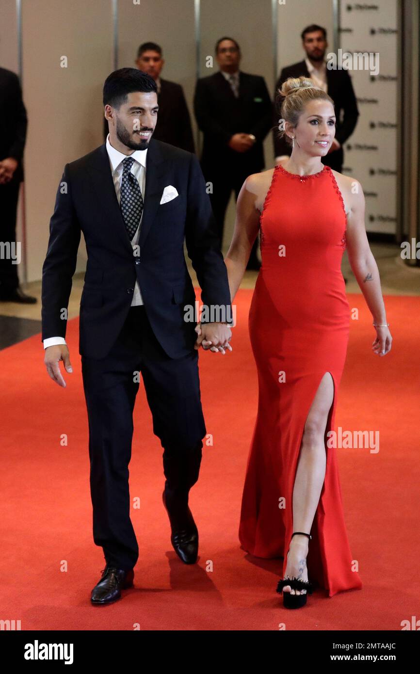 Uruguayan soccer star Luis Suarez and wife Sofia Balbi walk out on to ...