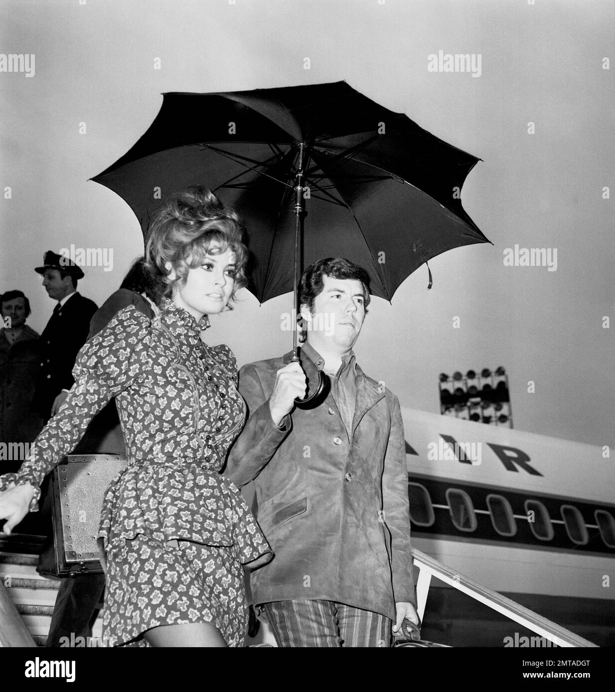 Raquel Welch and her husband Patrick Curtis arrive at Orly Airport, Paris, on January 14, 1970 ...