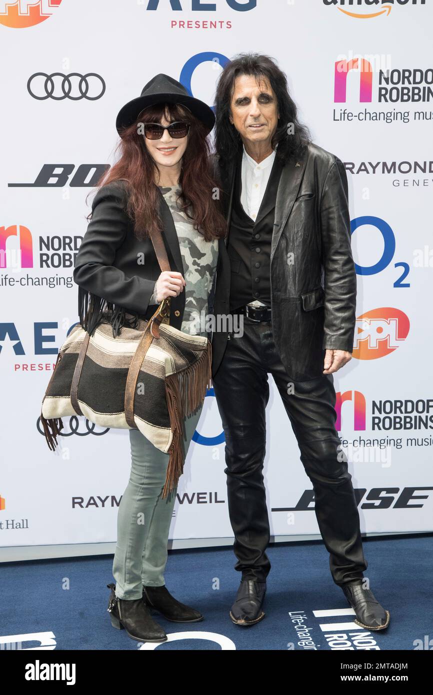 Alice Cooper and Sheryl Goddard pose for photographers upon arrival at ...