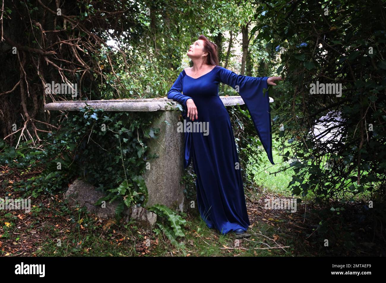 Beautiful gothic witch standing in an ancient cemetery - John Gollop ...