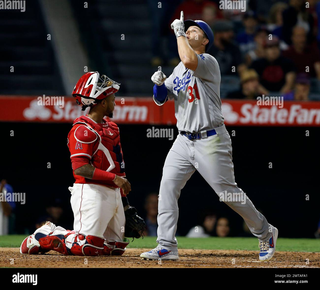 Los Angeles Dodgers' Joc Pederson, right, points to the sky after hitting a three-run home run ...