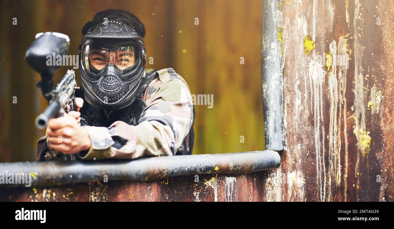 Paintball, gun and war with a sports man playing a military game for ...