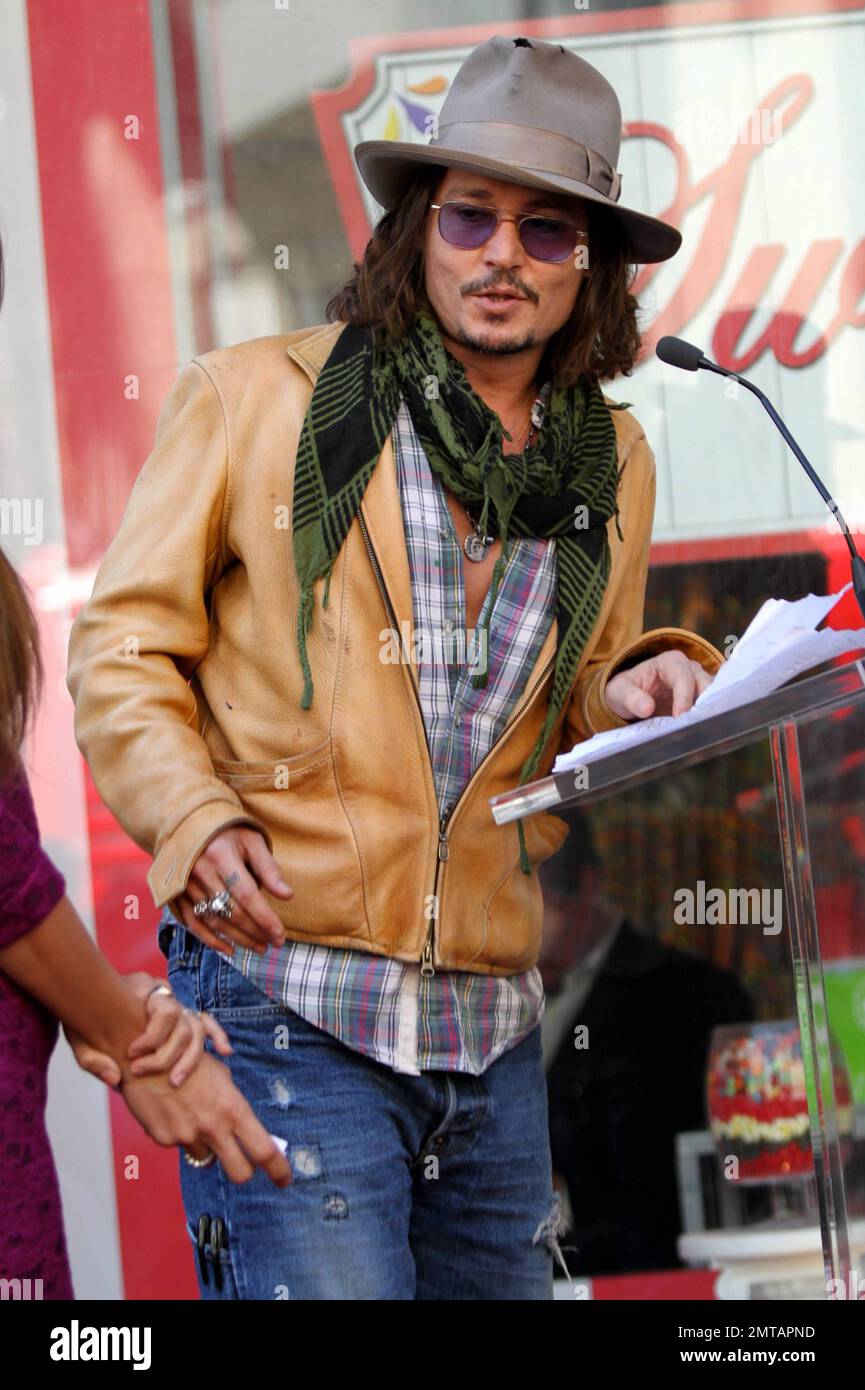 Actress Penelope Cruz wears a form-fitting purple dress showing off her ...