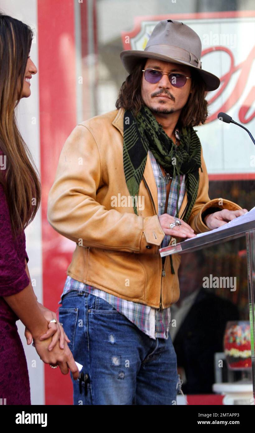 Actress Penelope Cruz wears a form-fitting purple dress showing off her ...