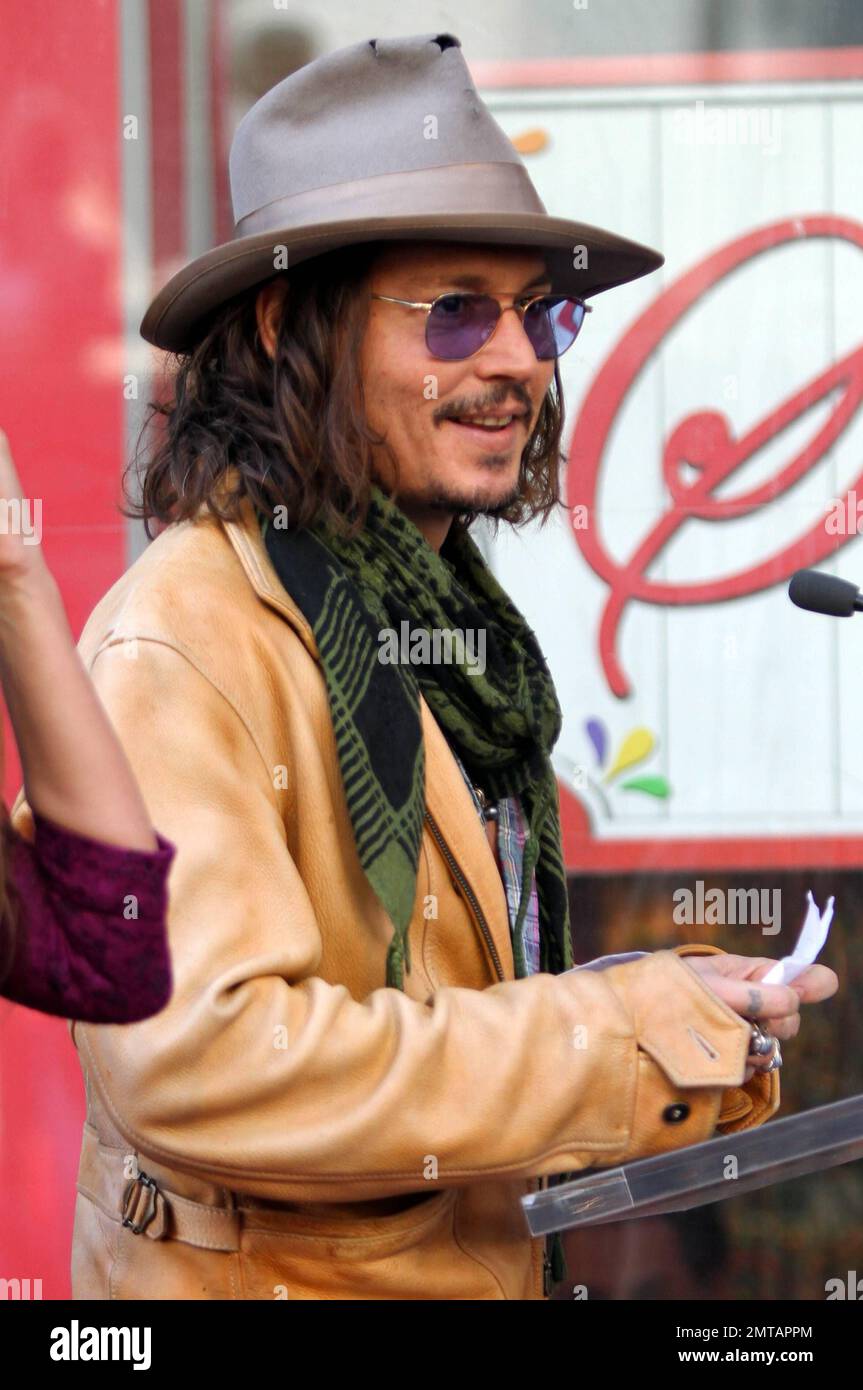 Actress Penelope Cruz wears a form-fitting purple dress showing off her ...