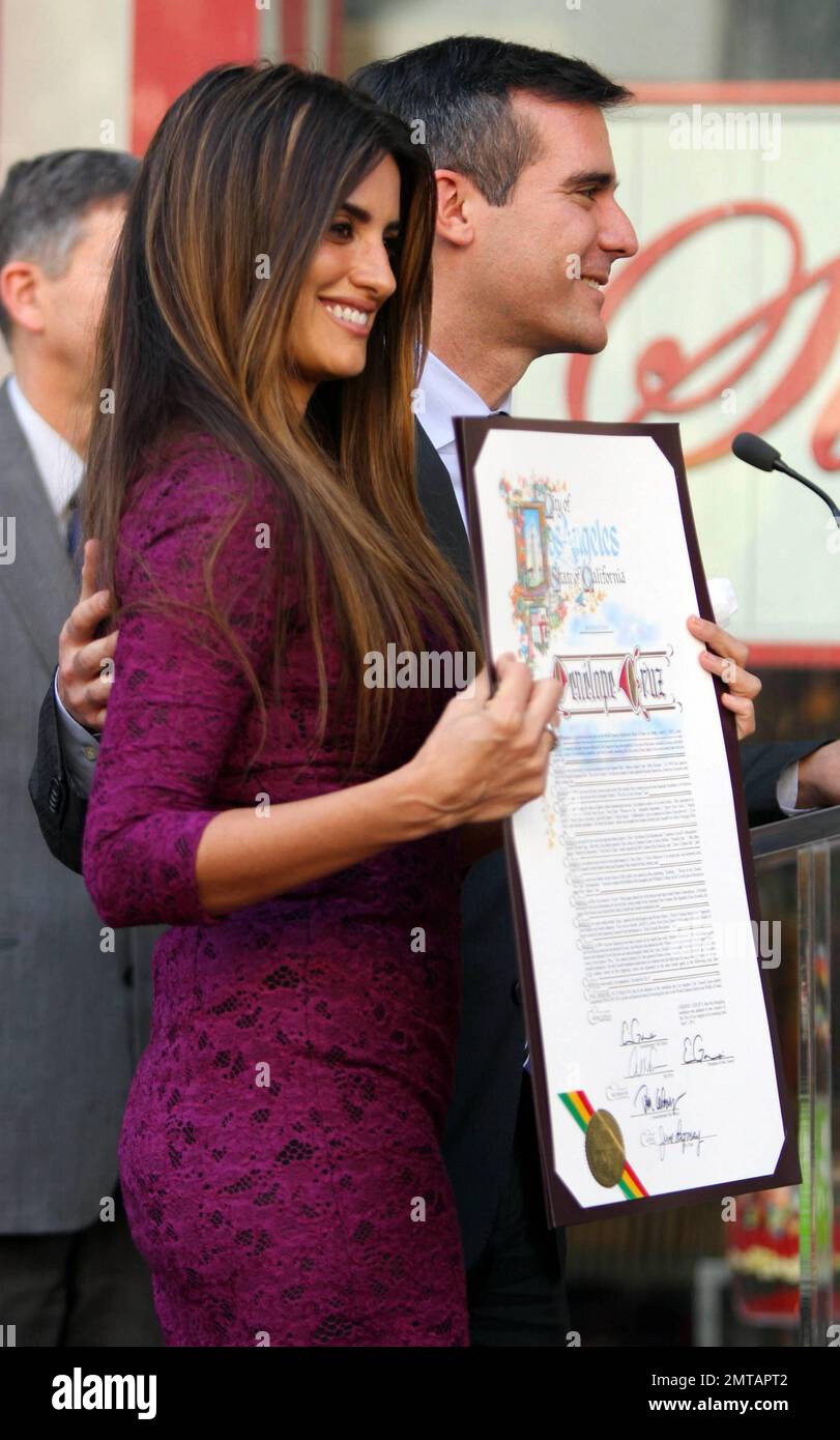 Actress Penelope Cruz wears a form-fitting purple dress showing off her ...