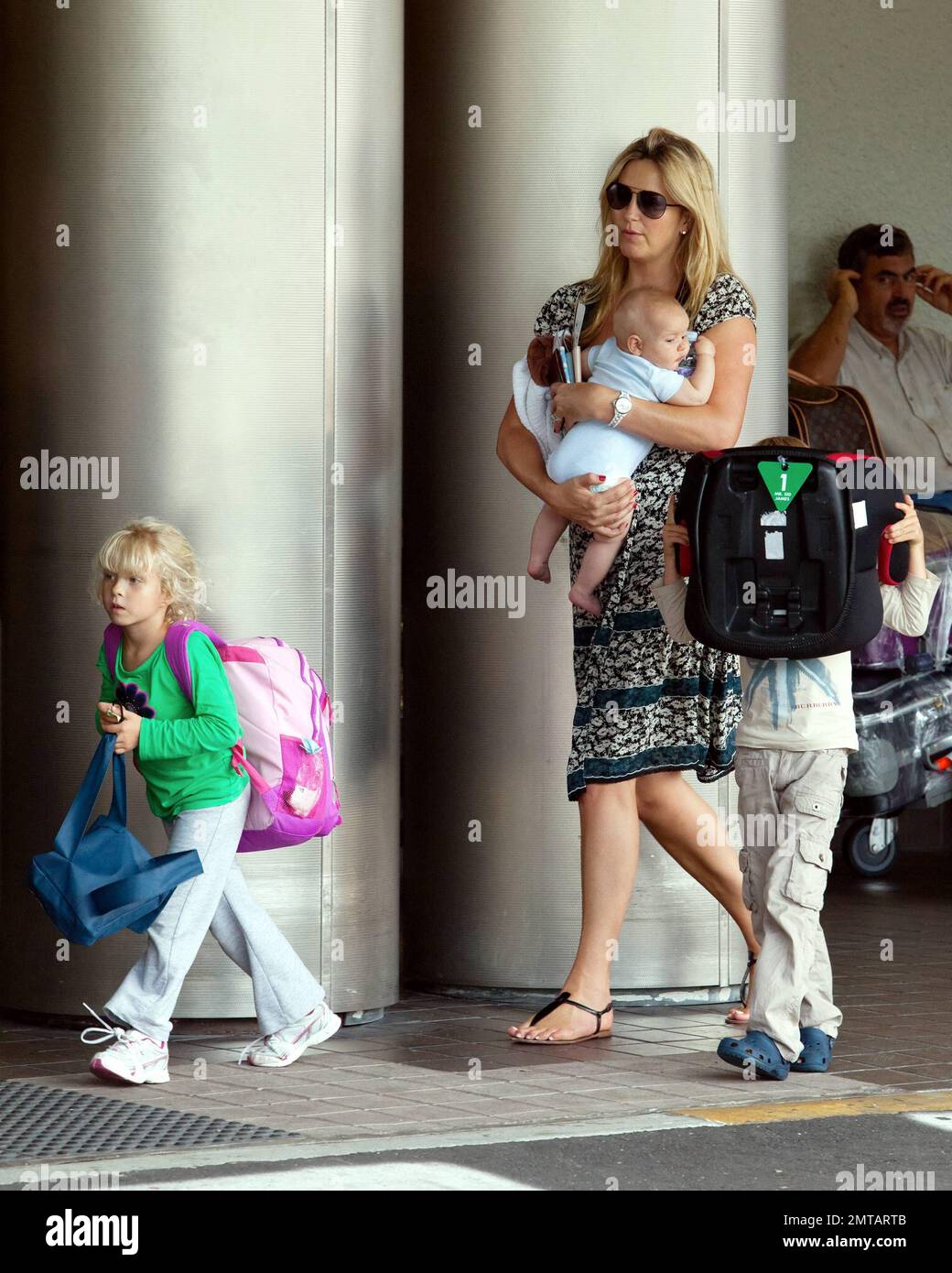 Penny Lancaster carries her infant son Aiden as she arrives at Miami ...