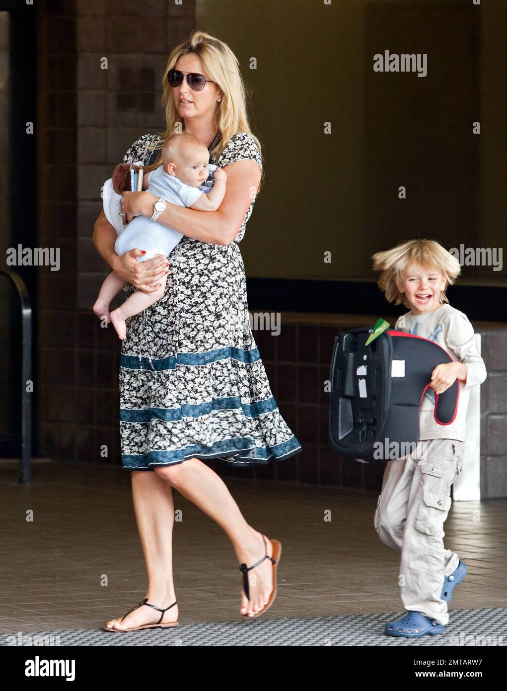 Penny Lancaster carries her infant son Aiden as she arrives at Miami ...