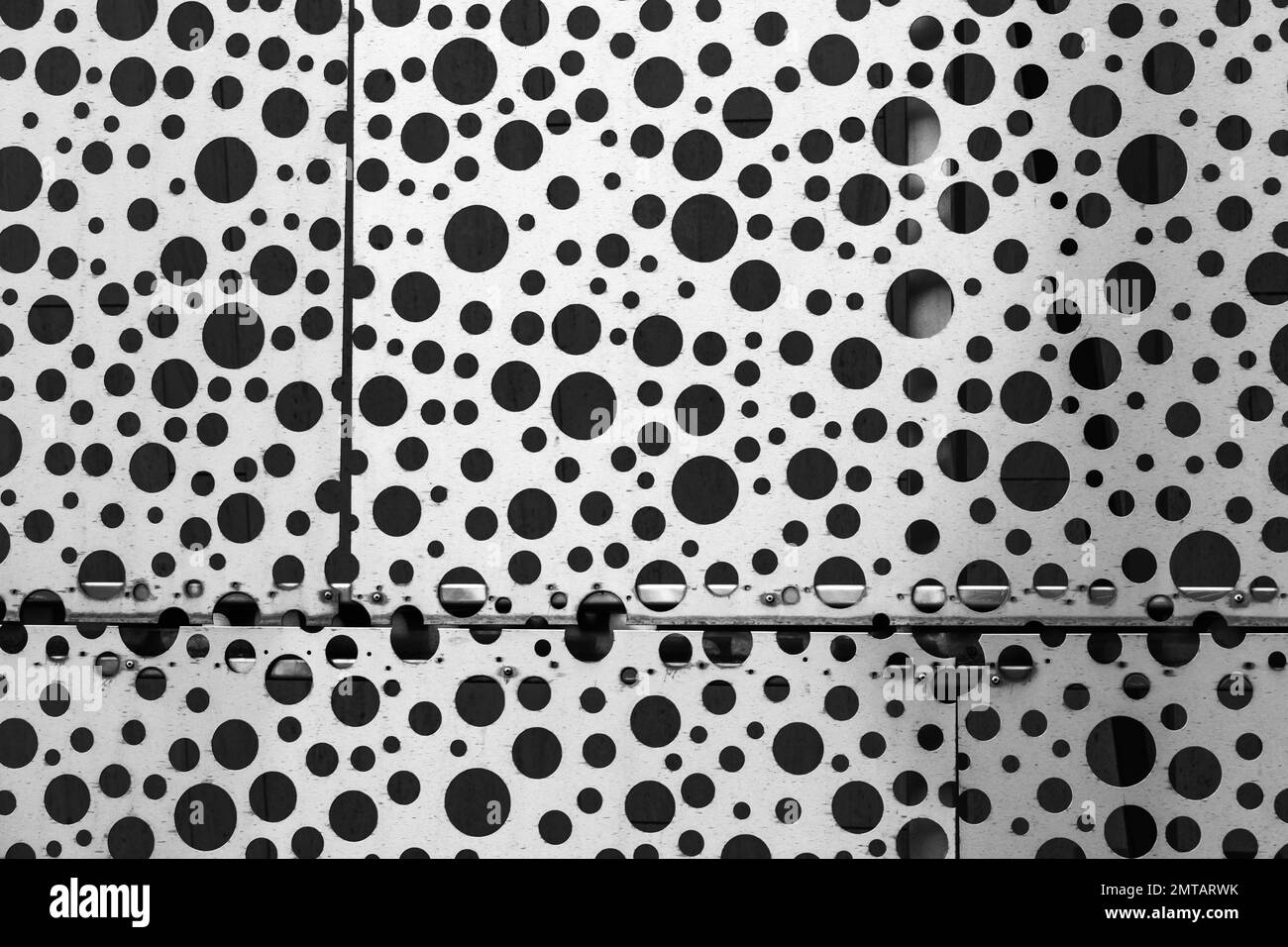 Shiny metal plate with round holes pattern, abstract industrial ...