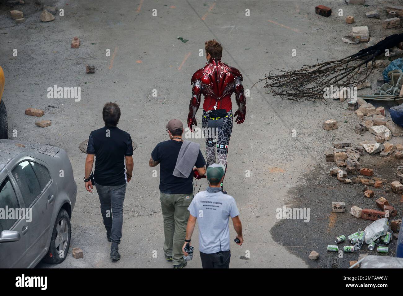 A cast member walks in an Iron Man costume during the filming of ...