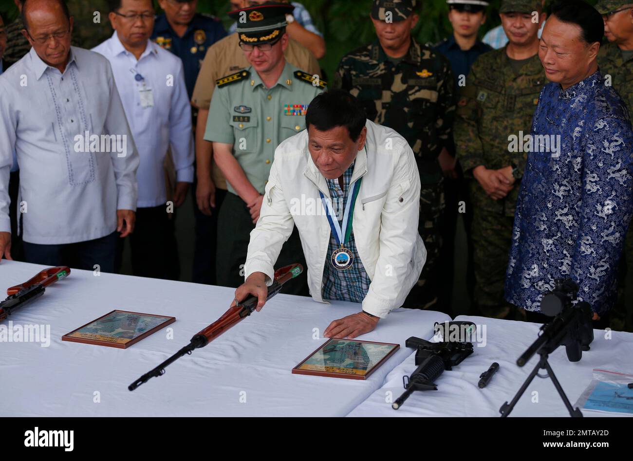 Philippine President Rodrigo Duterte checks the weight of a Chinese ...
