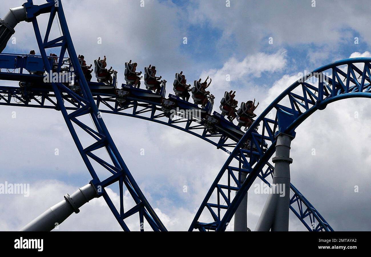 Visitors have their arms up as they ride in a roller coaster in Germany ...