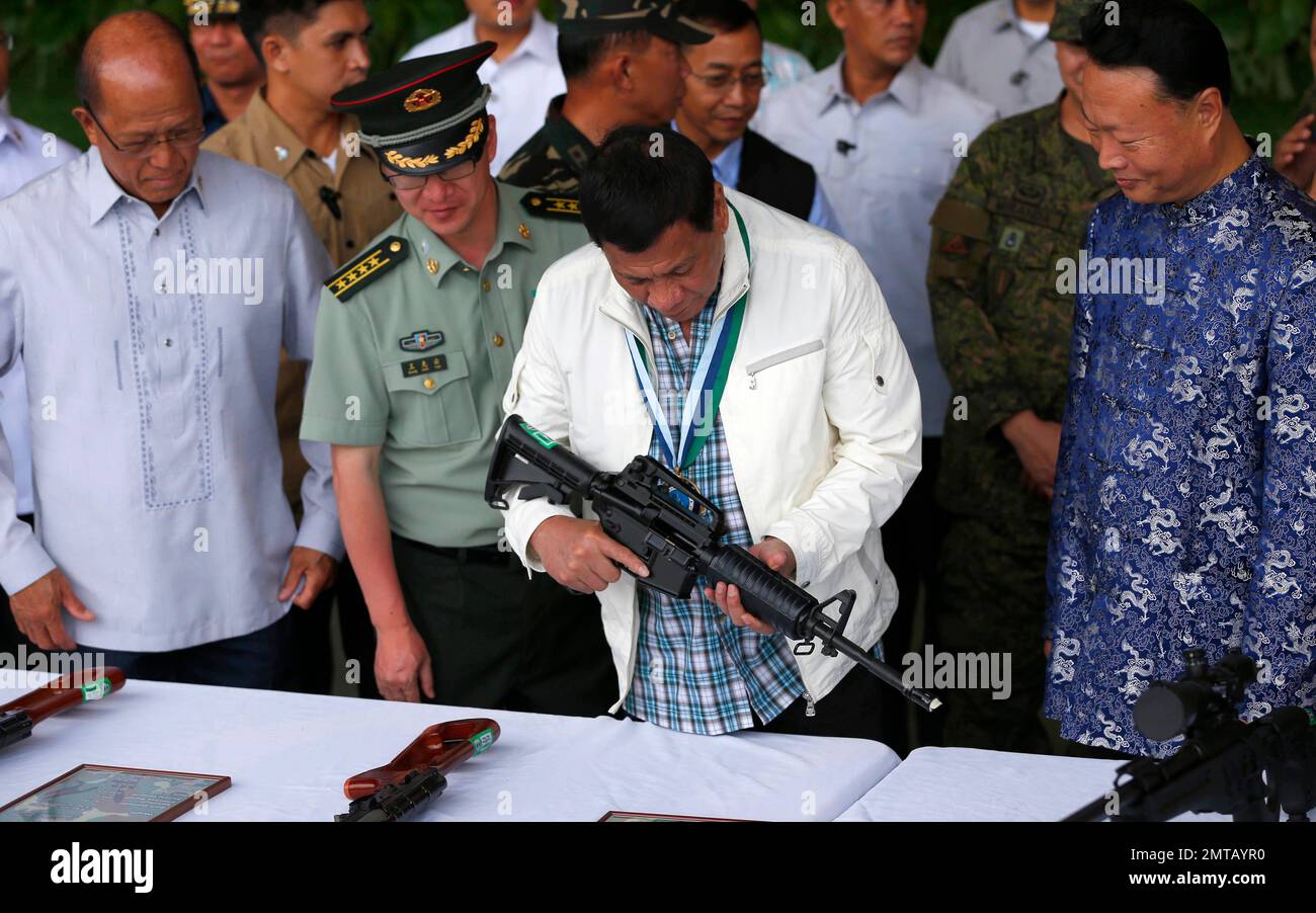 Philippine President Rodrigo Duterte holds a Chinese-made CQA5 assault ...