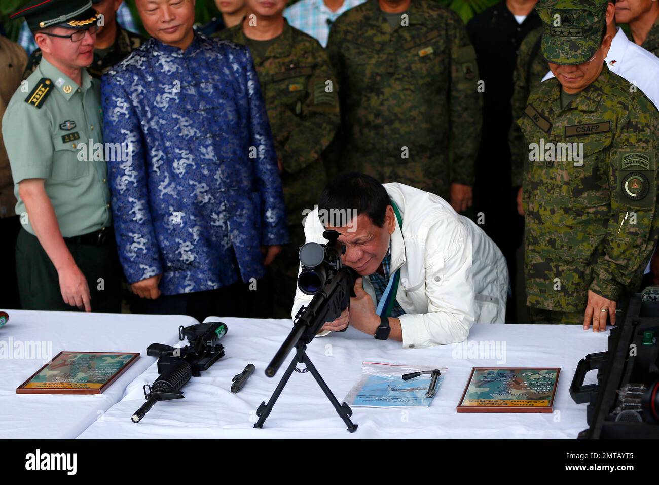 Philippine President Rodrigo Duterte checks the scope of a Chinese-made ...