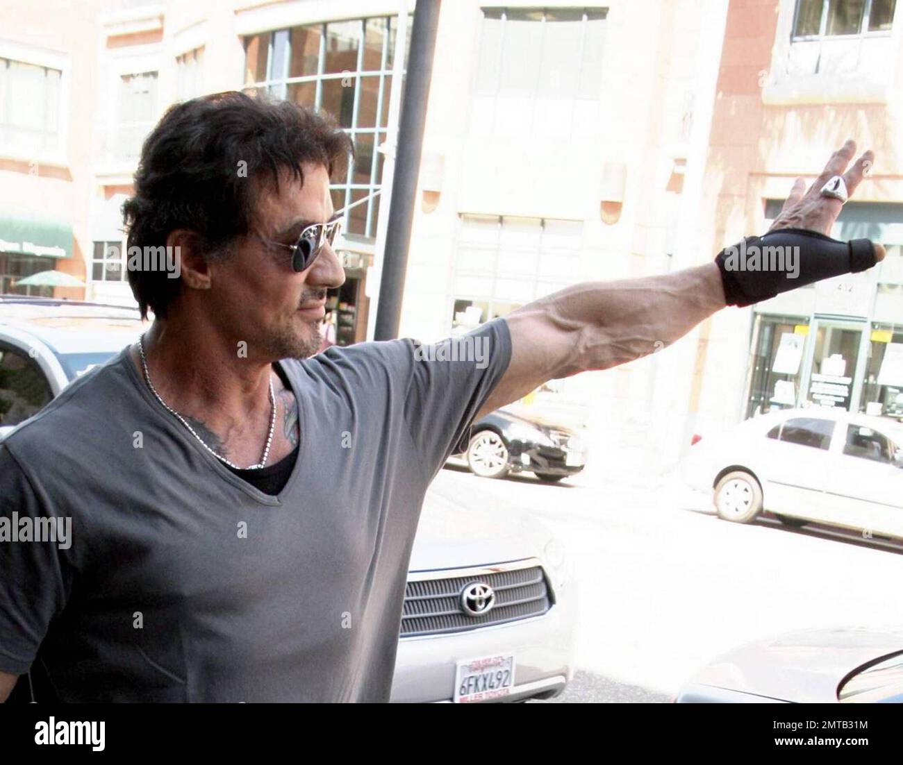 Actor Sylvester Stallone wears a brace around his wrist and thumb to ...