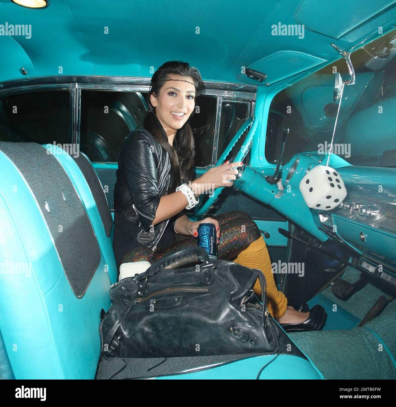 Kim Kardashian poses in an Aqua blue 50's classic car including fluffy ...