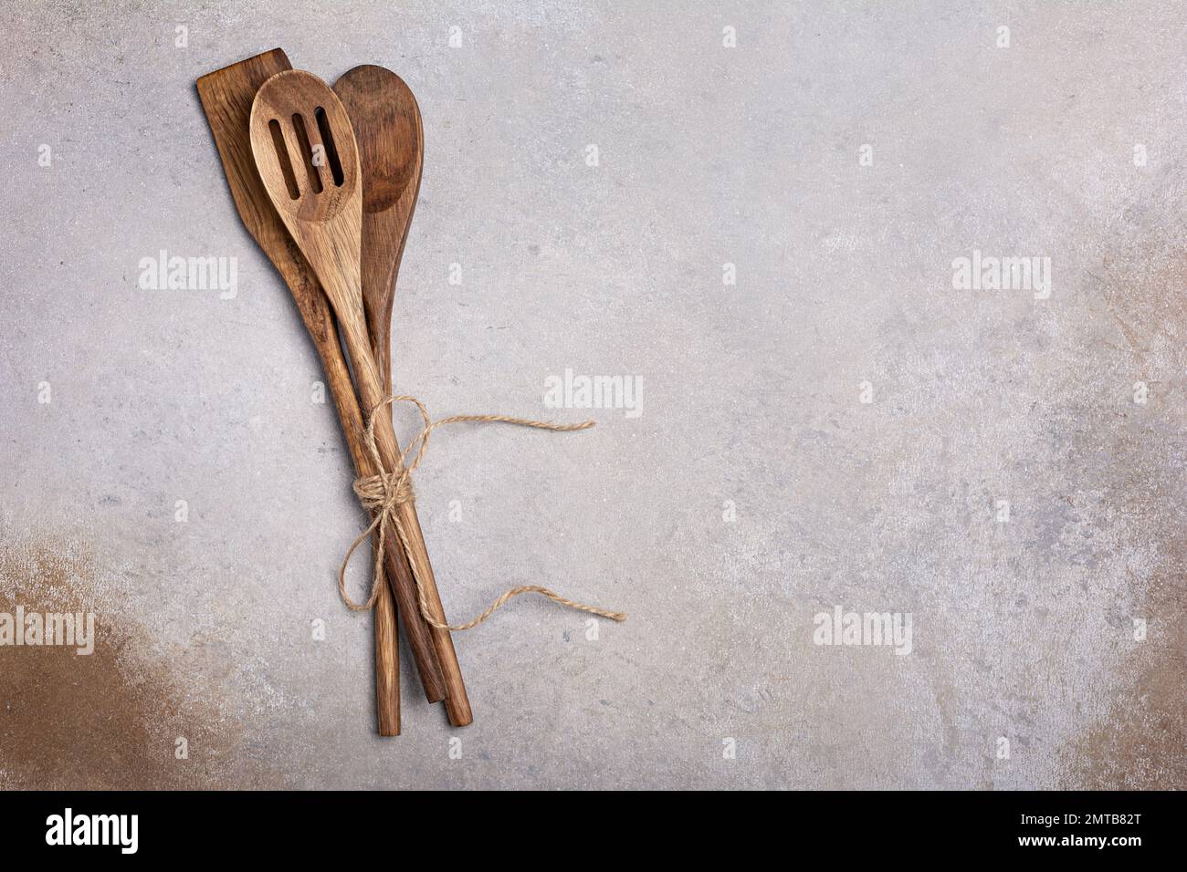 Utensils cutlery. Top view of rustic wooden scapula and spoons on grey ...