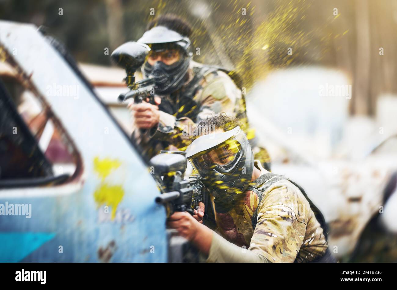 Paintball, shooting and people in action competition, game or match as ...