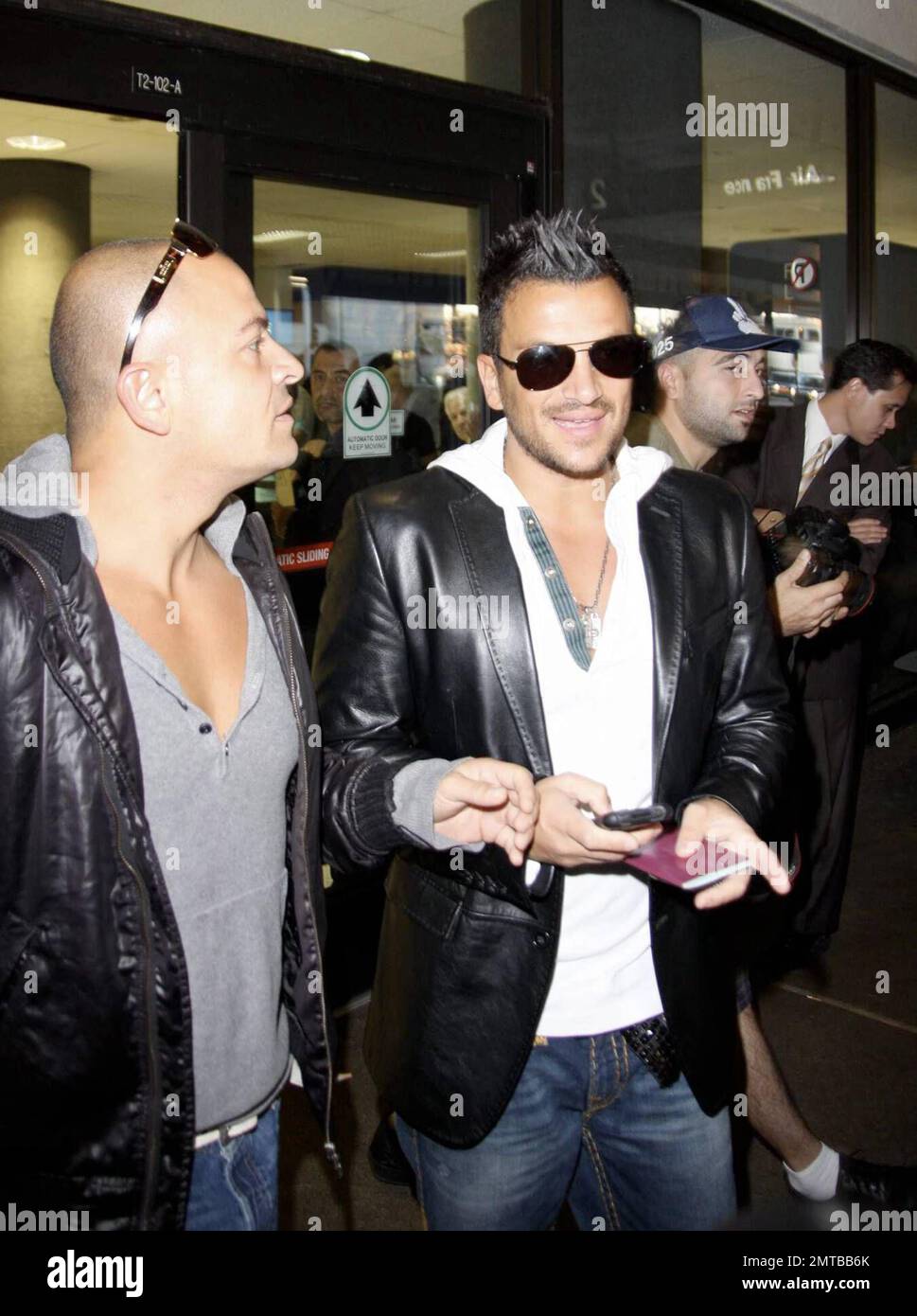 Peter Andre arrives at LAX with a gentleman he introduces as his ...