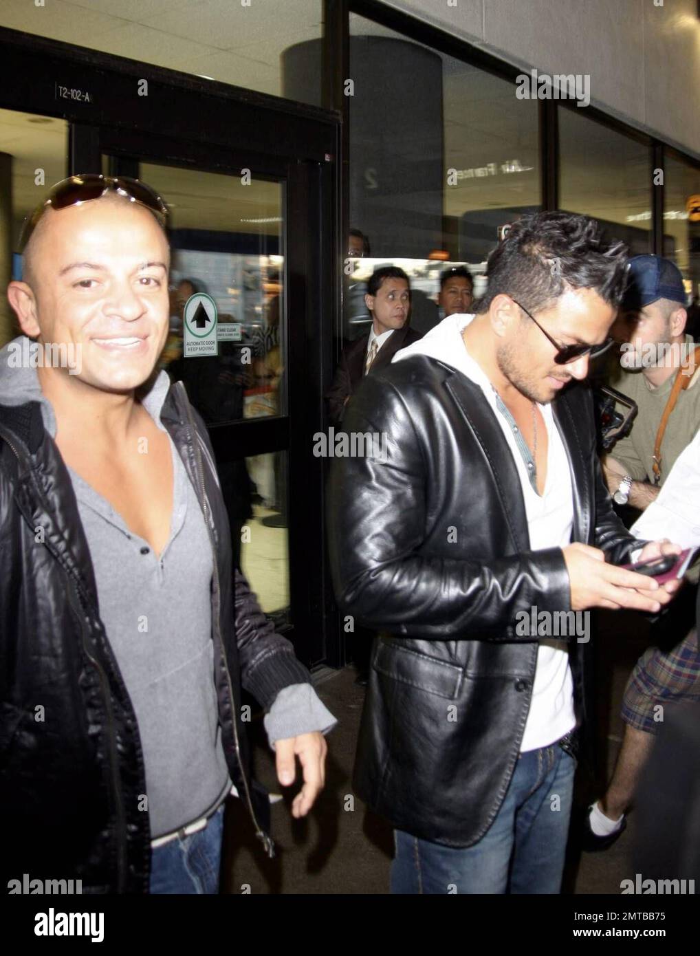 Peter Andre arrives at LAX with a gentleman he introduces as his ...