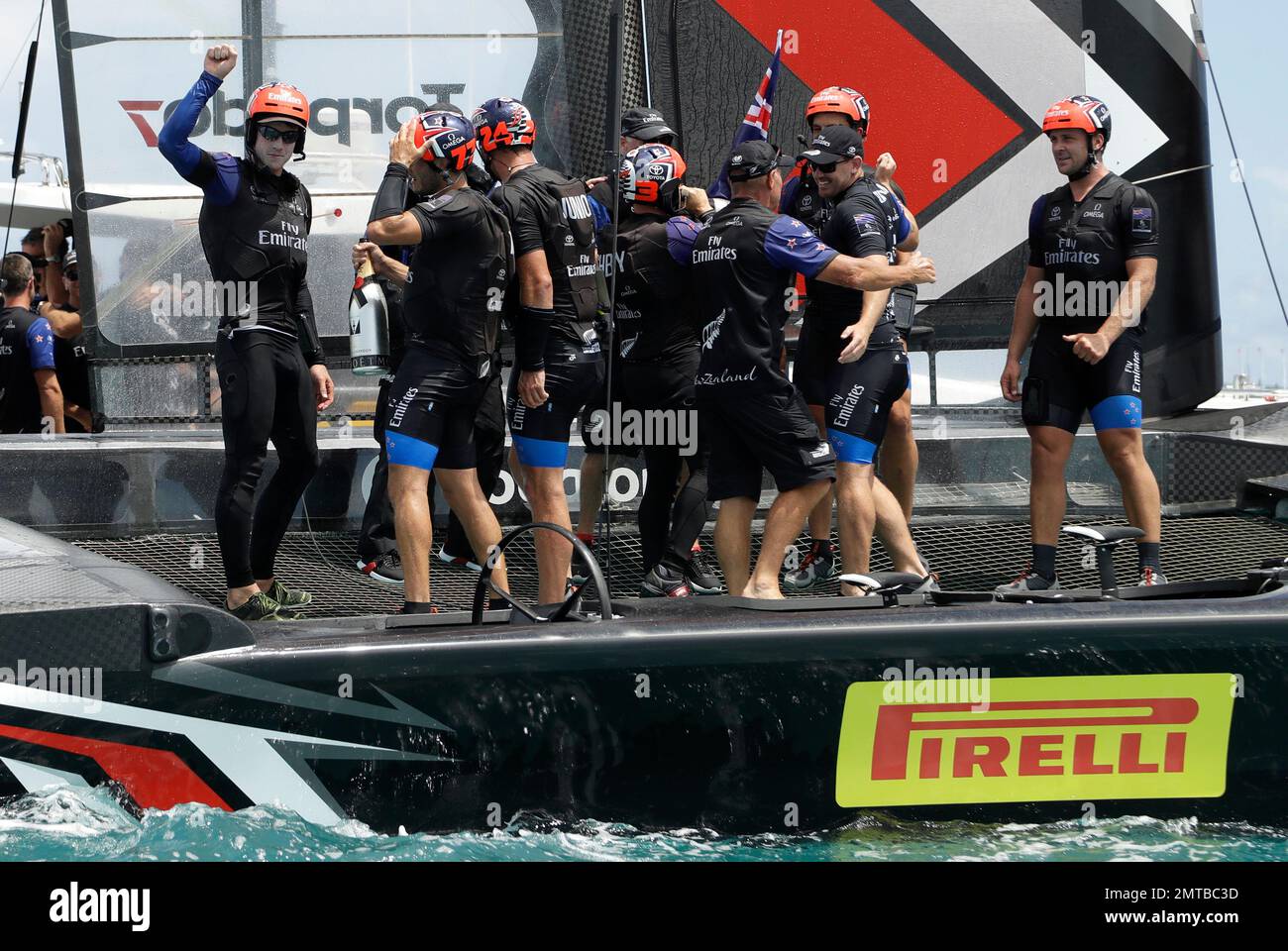 Emirates Team New Zealand helmsman Peter Burling, left, waves as his ...