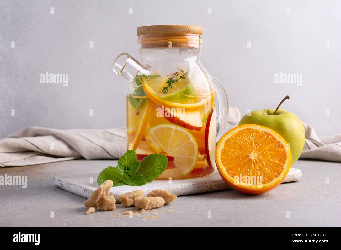 Homemade healthy hot fruit tea with fresh ripe orange, apple, mint ...