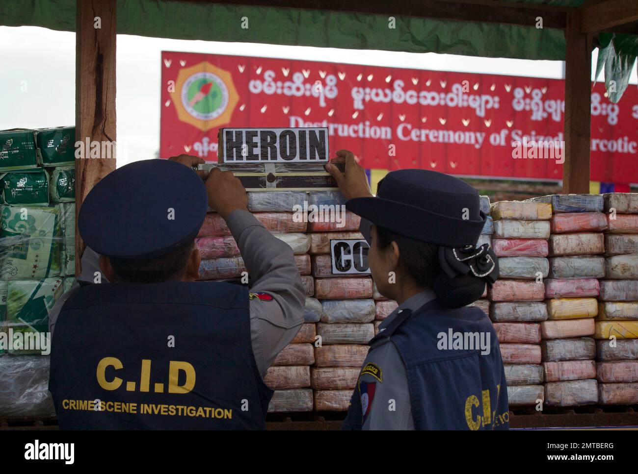 Myanmar police officers inspect seized drugs during a destruction ...