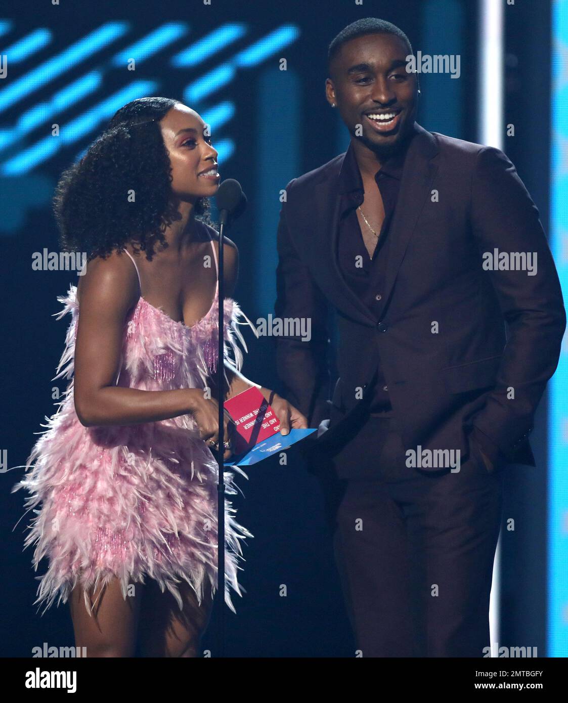 Logan Browning, left, and Demetrius Shipp Jr. present the award for ...