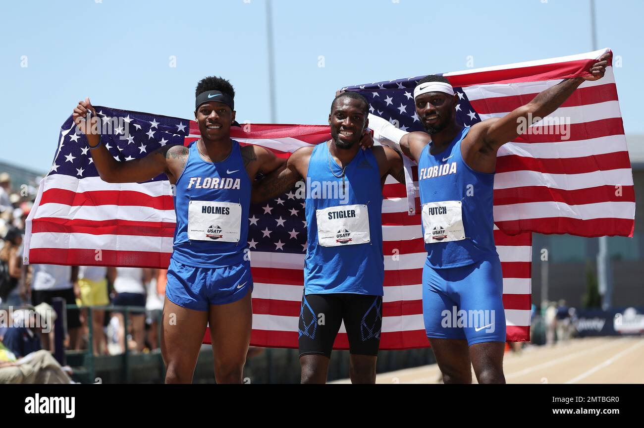 From left, TJ Holmes, Michael Stigler, and Eric Futch hold U.S. flags ...