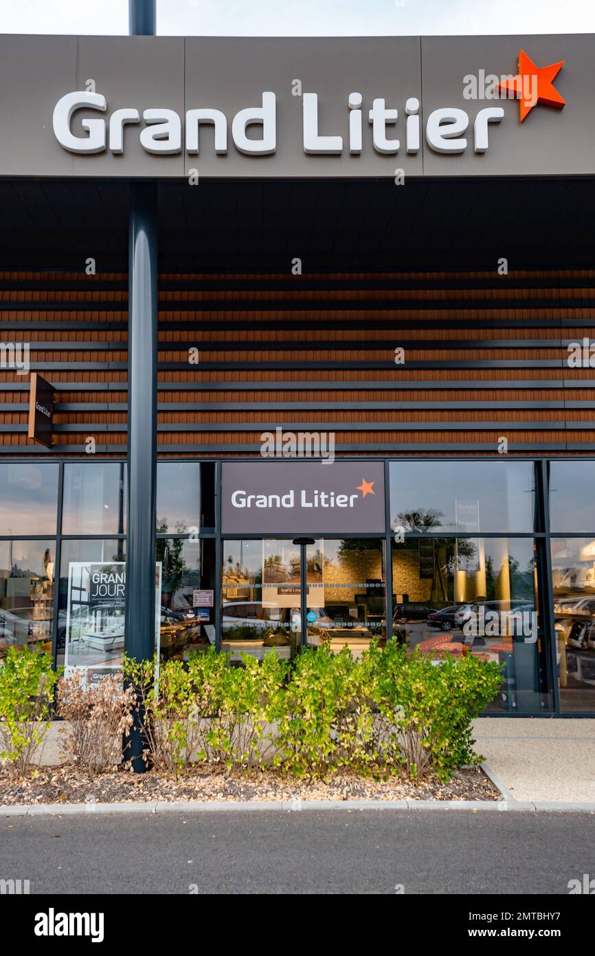A vertical shot of the Grand Litier front store facade with logo and ...