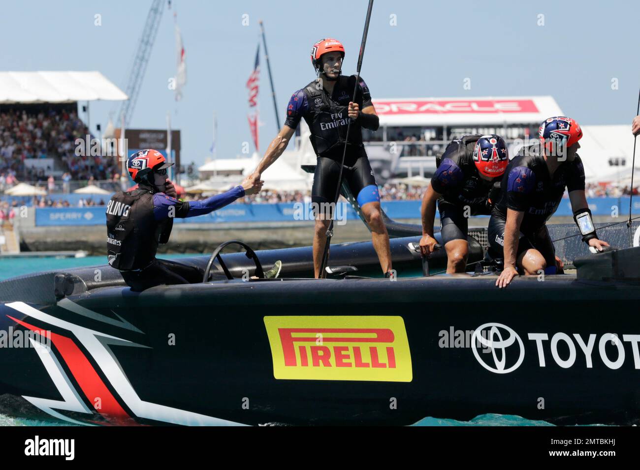 Emirates Team New Zealand helmsman Peter Burling, left, celebrates with ...