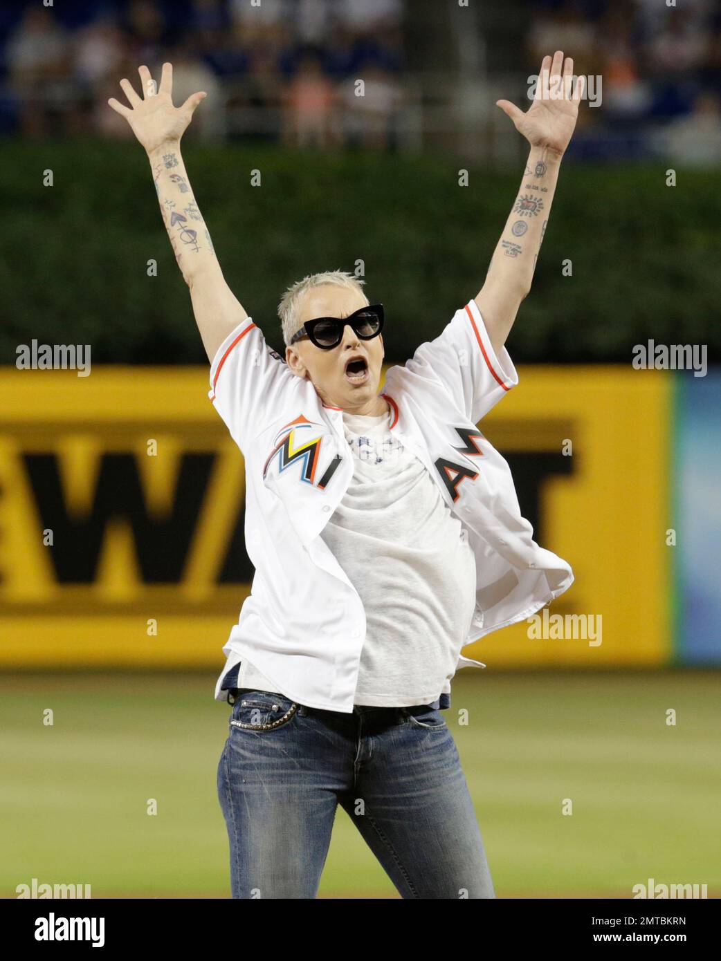 Actress Lori Petty reacts after throwing a ceremonial pitch before a ...