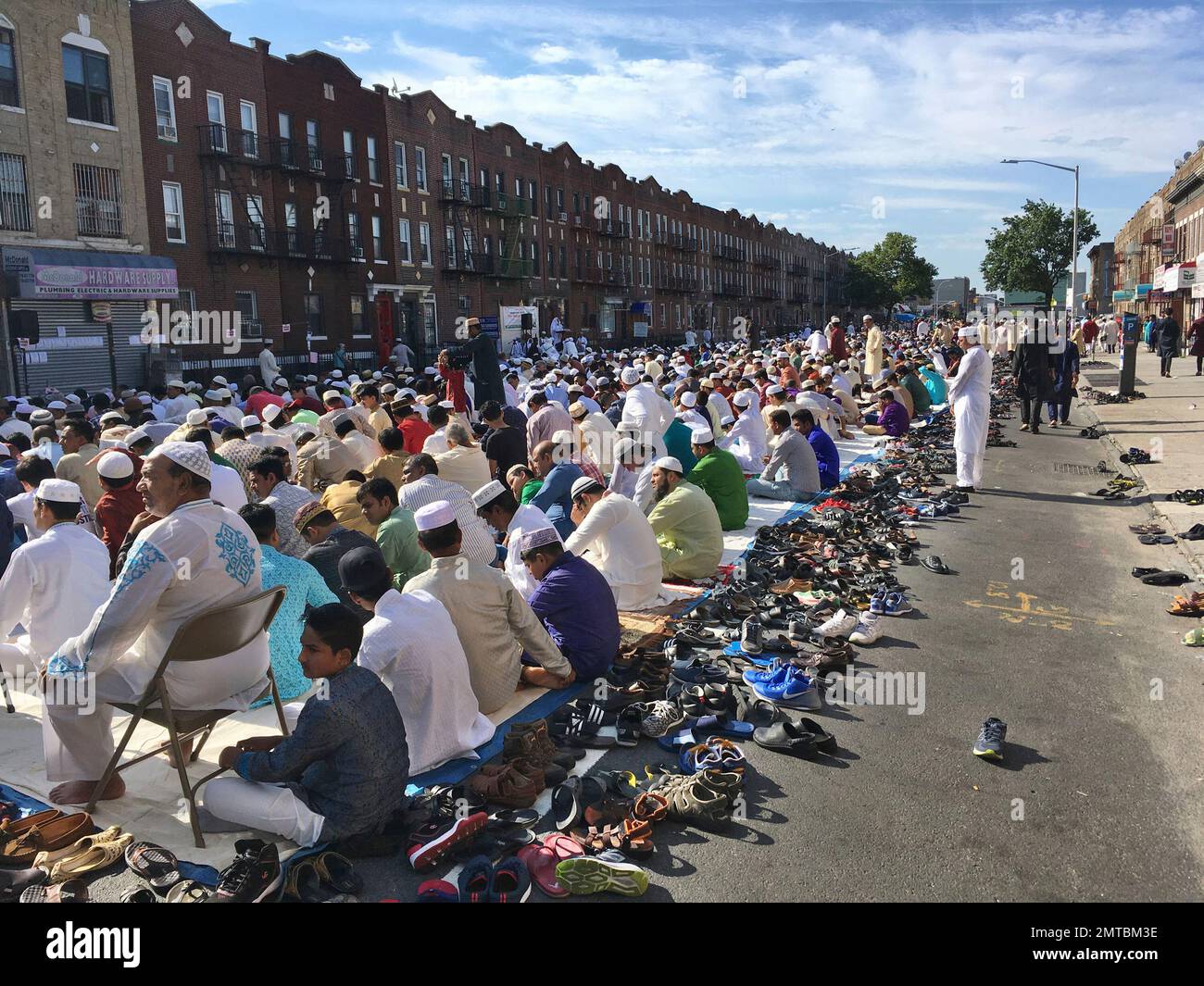 People gather on McDonald Ave., for a prayer celebration of Eid al-Fitr ...