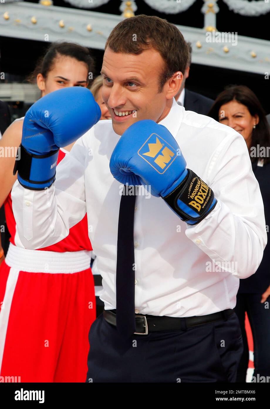 French President Emmanuel Macron spars with a boxer in Paris, France ...