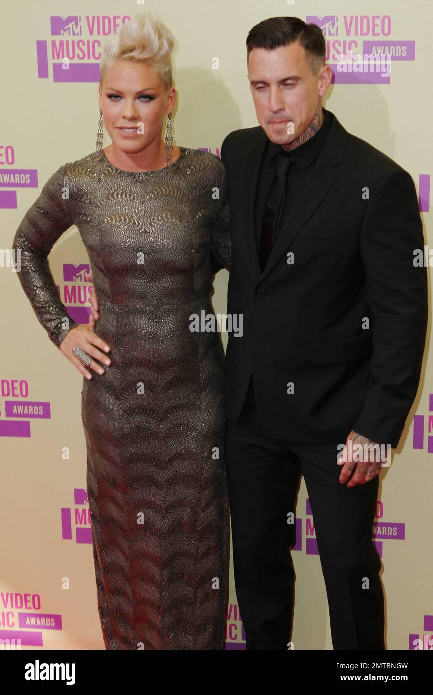 Wearing a silver patterned floor length dress with sparkling earrings ...