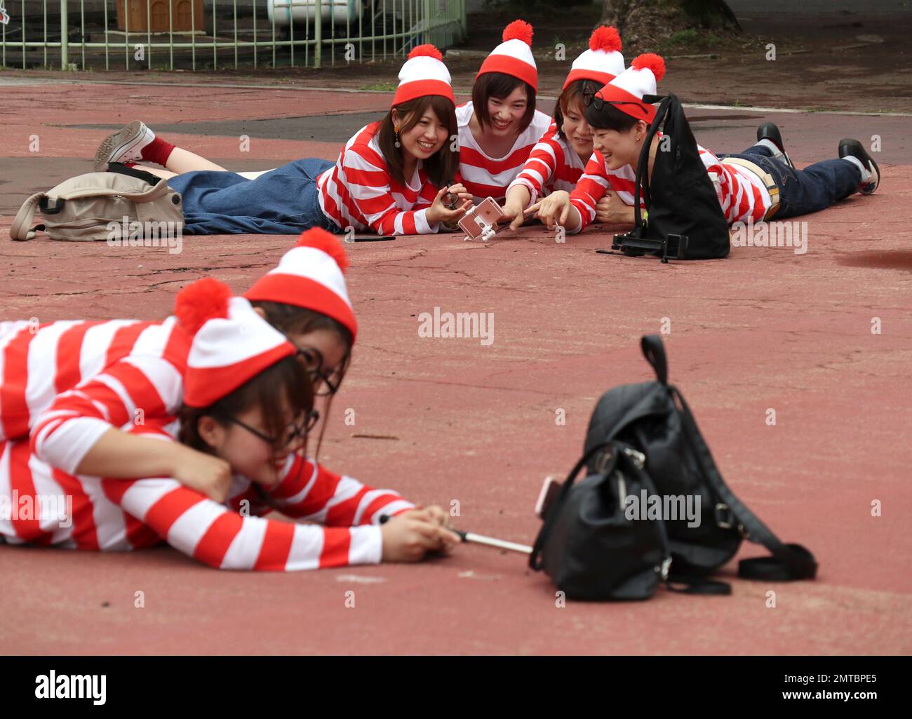 Participants dressed as Waldo of Where's Waldo take selfie in a Waldo ...