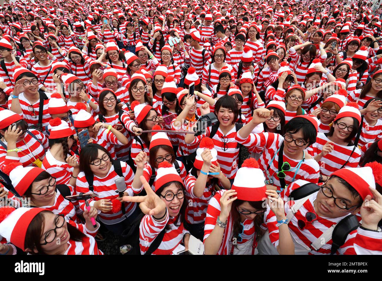 Participants dressed as Waldo of Where's Waldo pose together during a ...