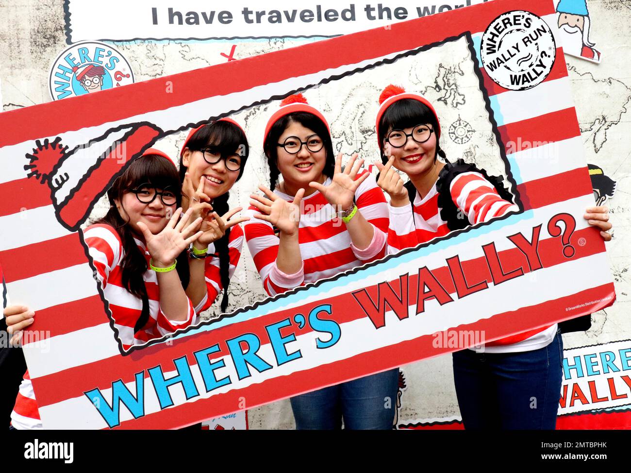 Participants dressed as Waldo of Where's Waldo pose for a photo during ...