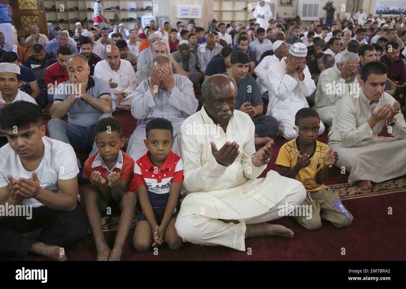 Iraqi Sunni Muslims pray on the first day of Eid al-Fitr prayers in ...