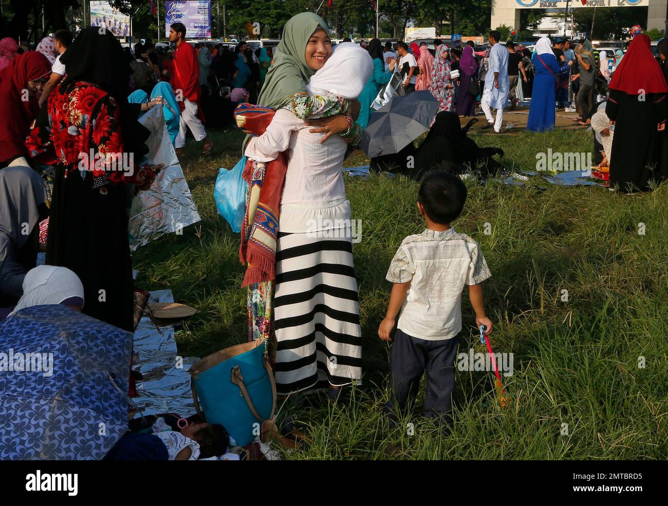 Filipino Muslims hug each other following the early morning prayers at ...