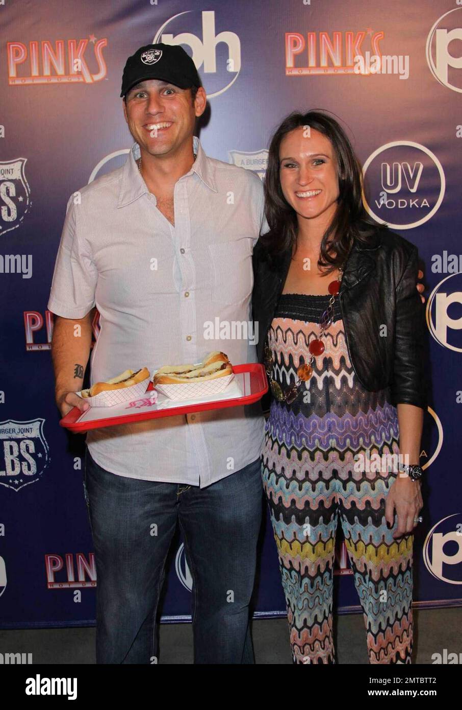 Owner Billy Pink and sister pose on the pink carpet with a hot dog to ...