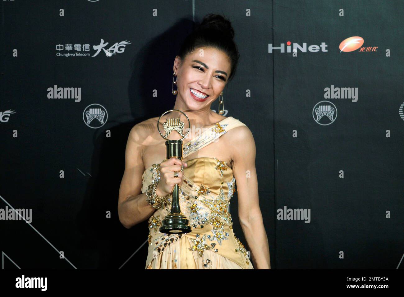 Taiwanese singer Eve Ai holds her award for the Best Female Mandarin ...