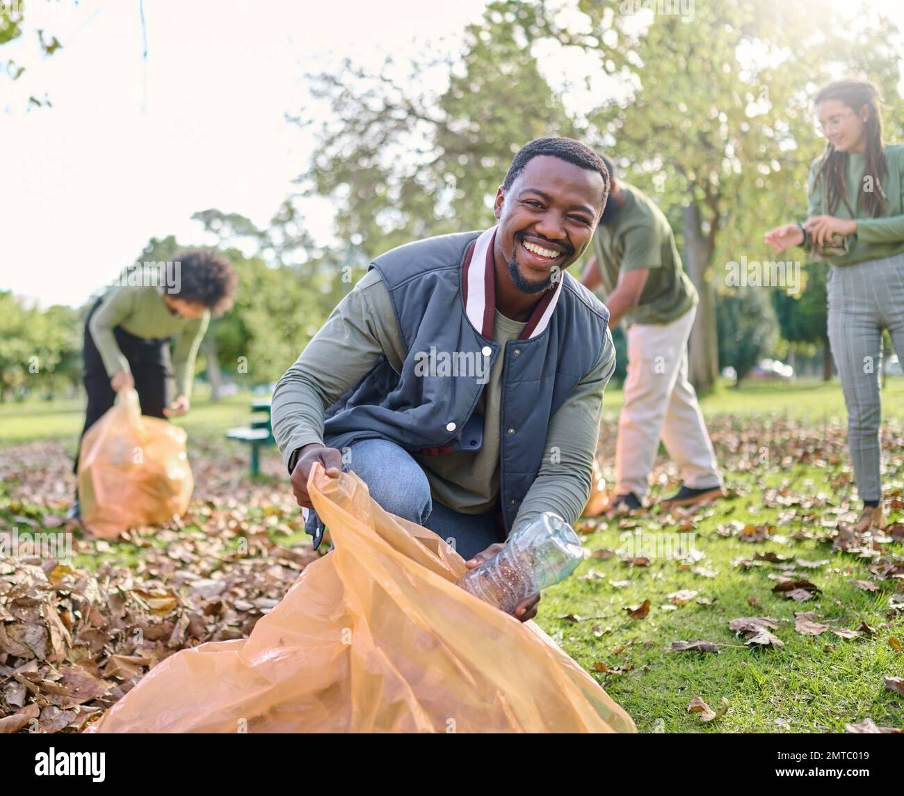 Trash, volunteer portrait and man cleaning garbage pollution, waste ...