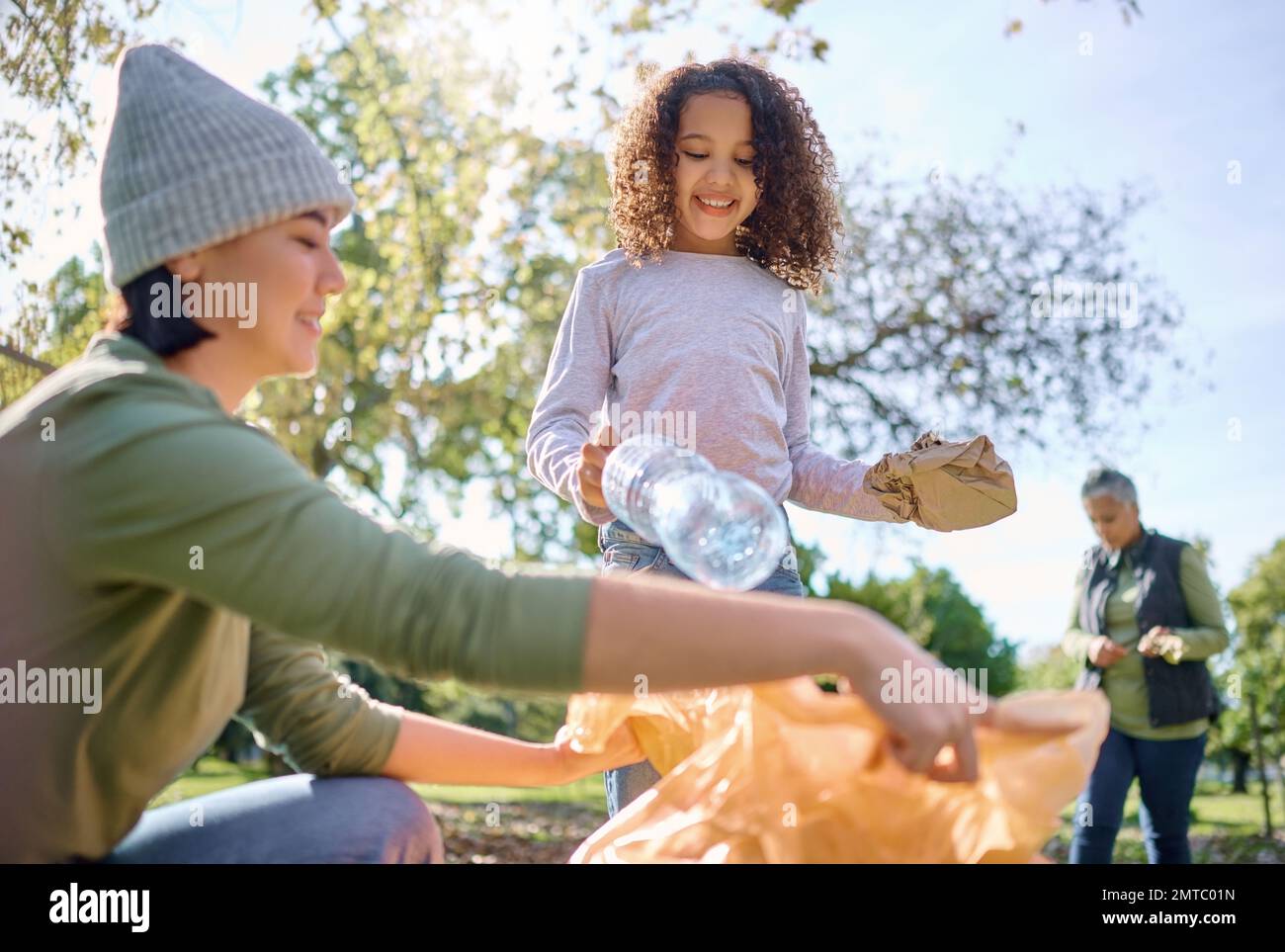 Recycle plastic, bottle and people with child in park for community ...