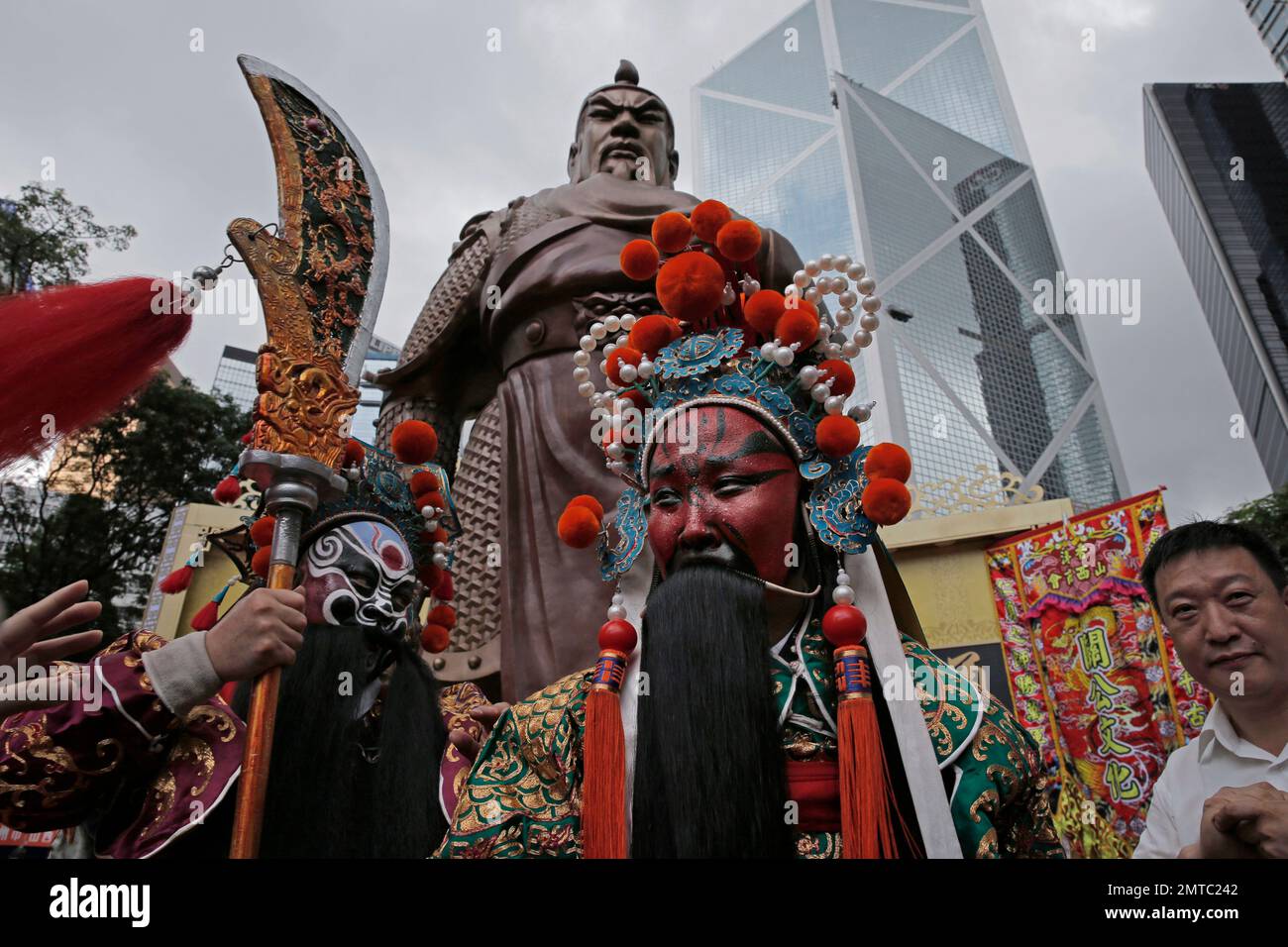 A performer dressed as a Guan Gong poses for photographers in front of ...