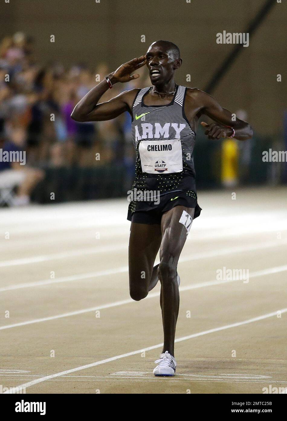 U.S. Army runner Paul Chelimo salutes as he finishes first in the men's ...