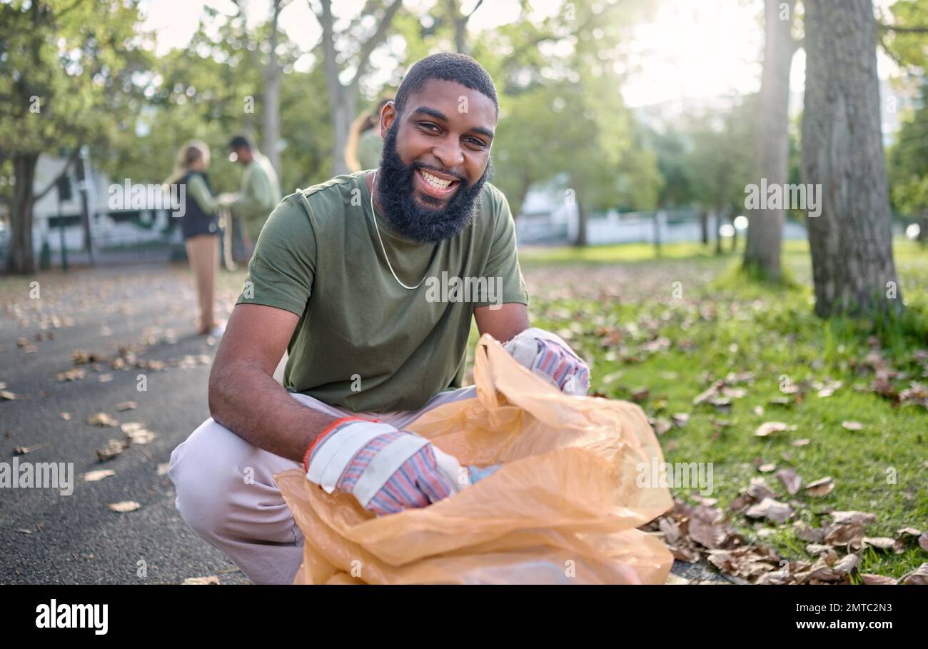Black man, volunteer portrait and plastic bag for community park ...